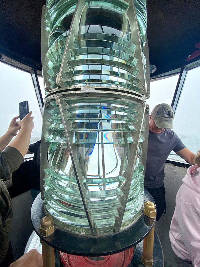 Inside the lantern room, surrounded by precision glass prisms that have guided sailors home for generations. Maritime technology at its most beautiful.