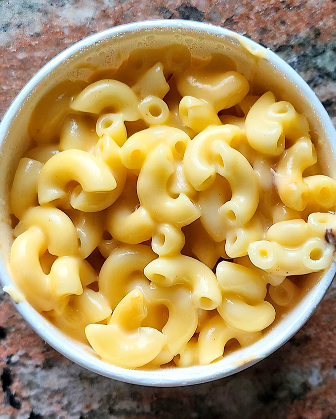 Mac and cheese so creamy it should come with a warning label. Each spiral pasta curve perfectly engineered to transport maximum cheese to mouth.