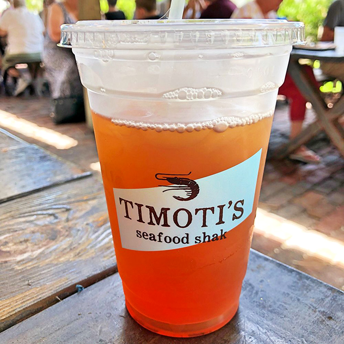 That vibrant orange mango tea isn't just a beverage; it's Florida sunshine in liquid form, branded with the promise of seafood excellence to come.