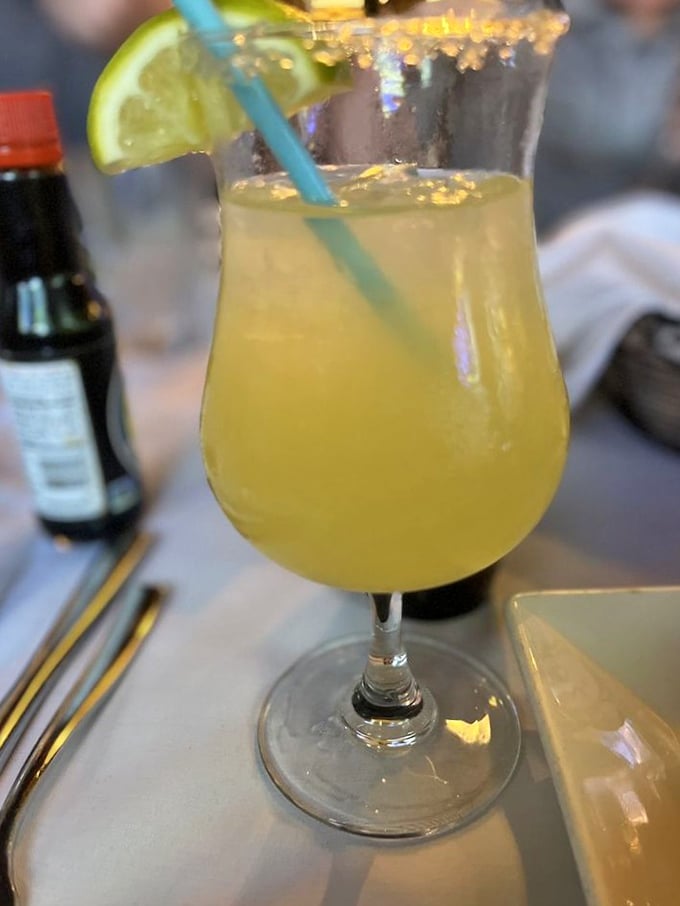 The margarita arrives like liquid sunshine in a glass, with a salt rim that reminds you of the nearby ocean and a lime that means business.