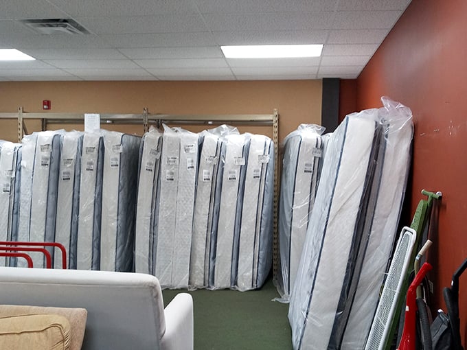 Mattresses standing at attention like soldiers, each one offering the promise of better sleep without the showroom markup.