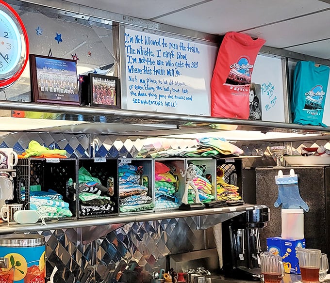 Diner philosophy hangs above merchandise shelves: wisdom served alongside t-shirts and coffee mugs for those who want to take the experience home.