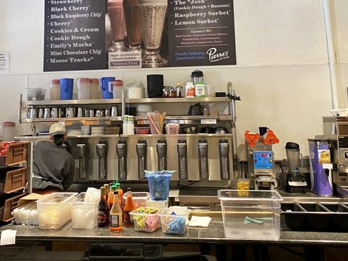 Behind the counter magic where milkshake dreams come true. The peace sign artwork above perfectly captures Tommy's harmonious blend of food and philosophy.