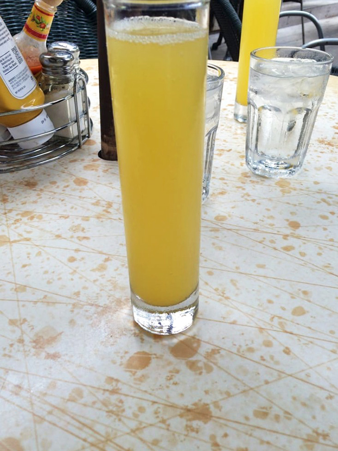 A mimosa tall enough to require its own zip code. Sunshine in a glass that makes "morning person" sound less offensive.
