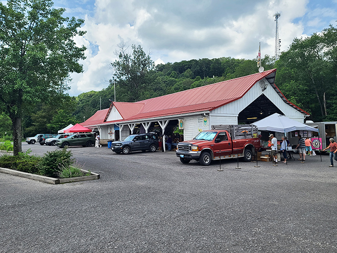 A farmers market with a red roof that's been sheltering local produce and neighborly gossip for generations.