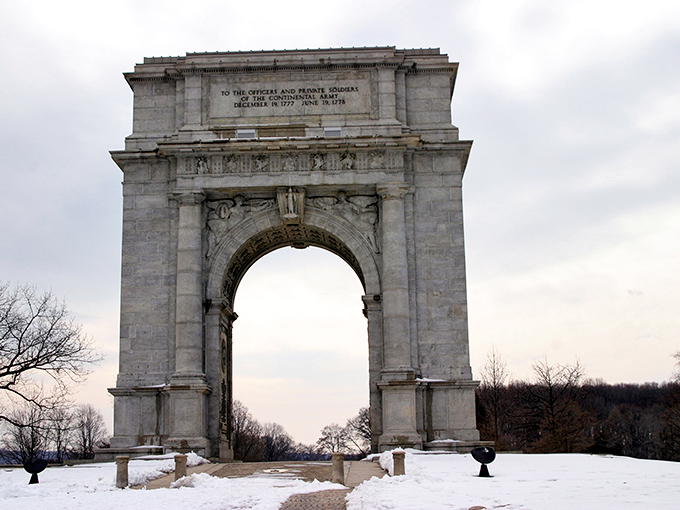 Snow blankets the Memorial Arch like nature's own tribute to those who endured winter's harshest test.
