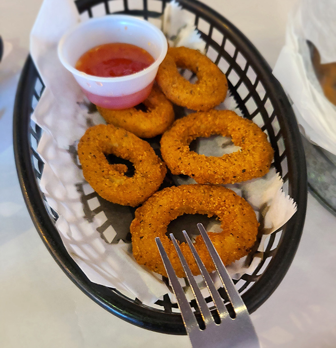 Golden-fried onion rings that crunch like autumn leaves—simple pleasures that remind us sometimes the side dishes deserve their own standing ovation.