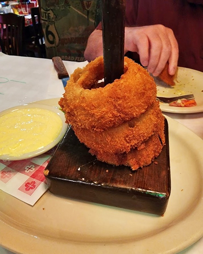 These onion rings aren't just stacked&mdash;they're practically architectural, with a golden crust that shatters with each bite and a side of heavenly dipping sauce.