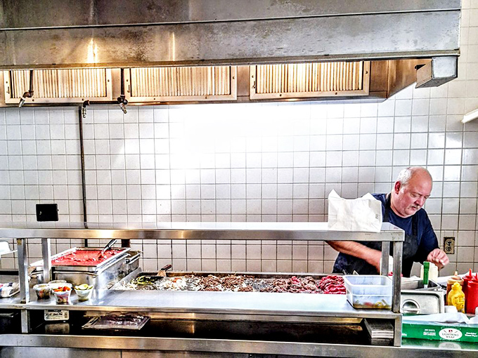 Where the magic happens &ndash; the open kitchen gives you a front-row seat to the choreographed chaos of cheesesteak creation.