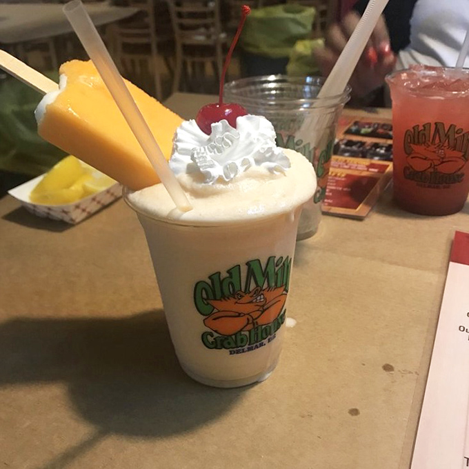 The Orange Creamsicle cocktail: childhood nostalgia with an adult upgrade. That popsicle garnish is pure vacation in a glass.