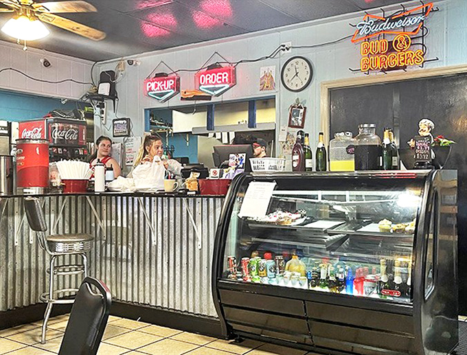 Behind that corrugated metal counter, breakfast dreams become reality while staff members maintain the delicate choreography of diner service.