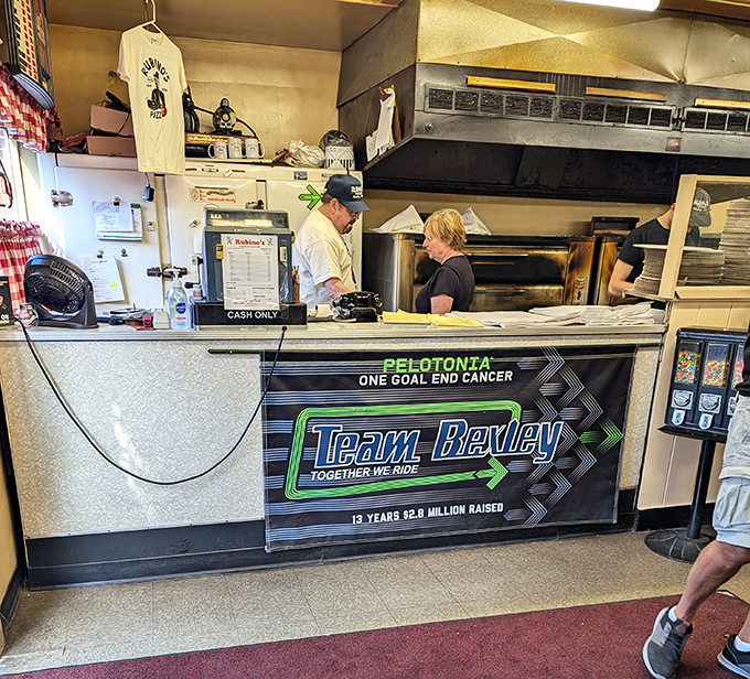 Behind this counter, pizza wizards have been performing the same delicious magic trick since before most of us were born.