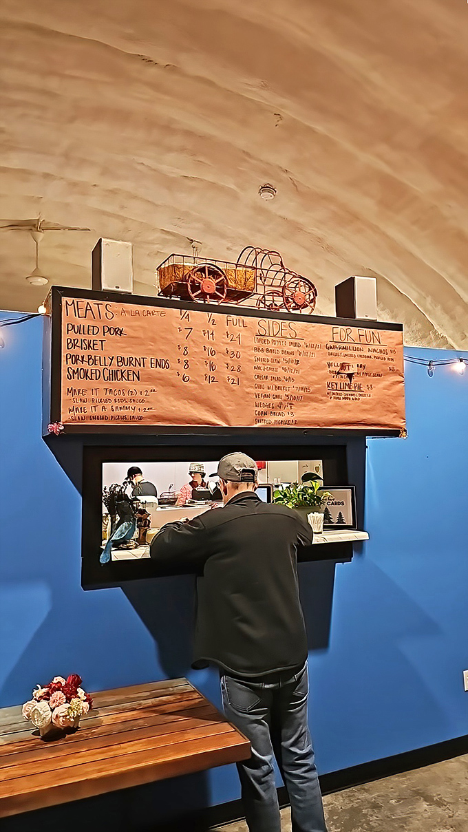 The ordering window—that magical portal where dreams are spoken aloud and return as smoked meat reality. Choose wisely, friends.