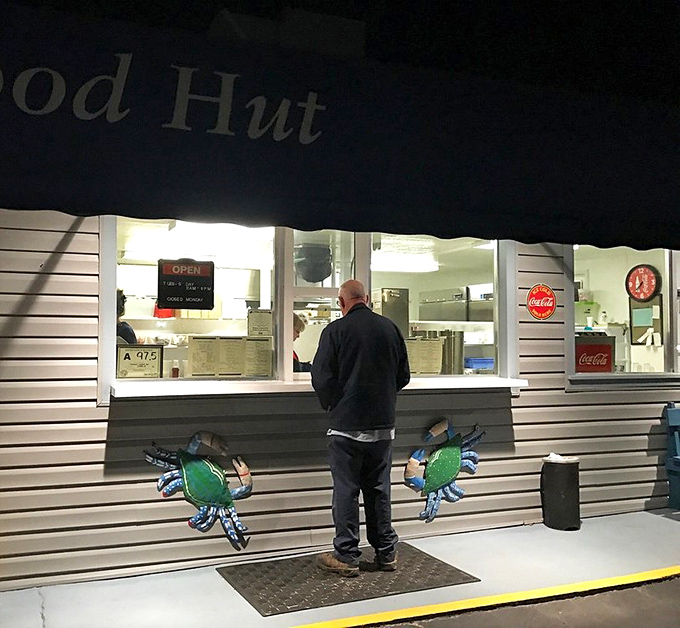 Late-night seafood quests end at this window, where fried dreams come true. The blue crab decorations aren't just cute—they're a promise.