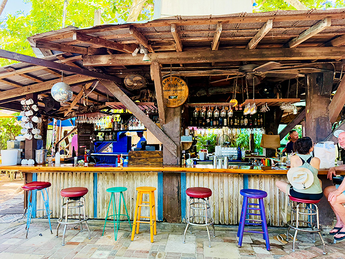 Inside the rustic bar where colorful stools invite you to belly up for a proper tropical cocktail after your banana bread pilgrimage.