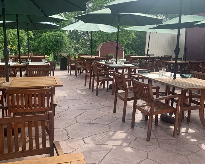 The patio at dusk: where umbrellas stand guard over tables that have witnessed countless "I need to unbutton my pants" moments of dining satisfaction.