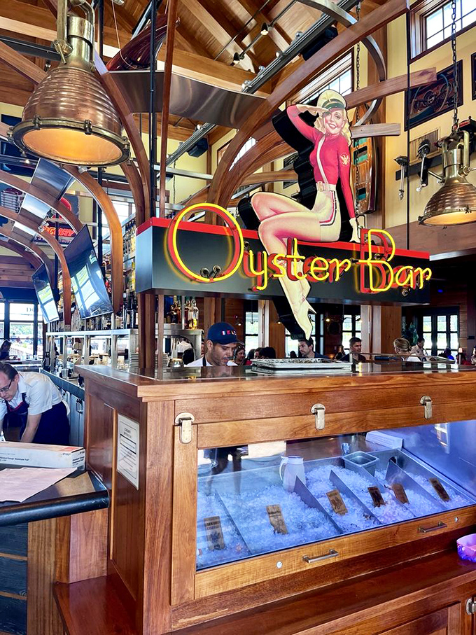 The Oyster Bar sign floats above fresh seafood treasures, a neon promise of briny delights to come.