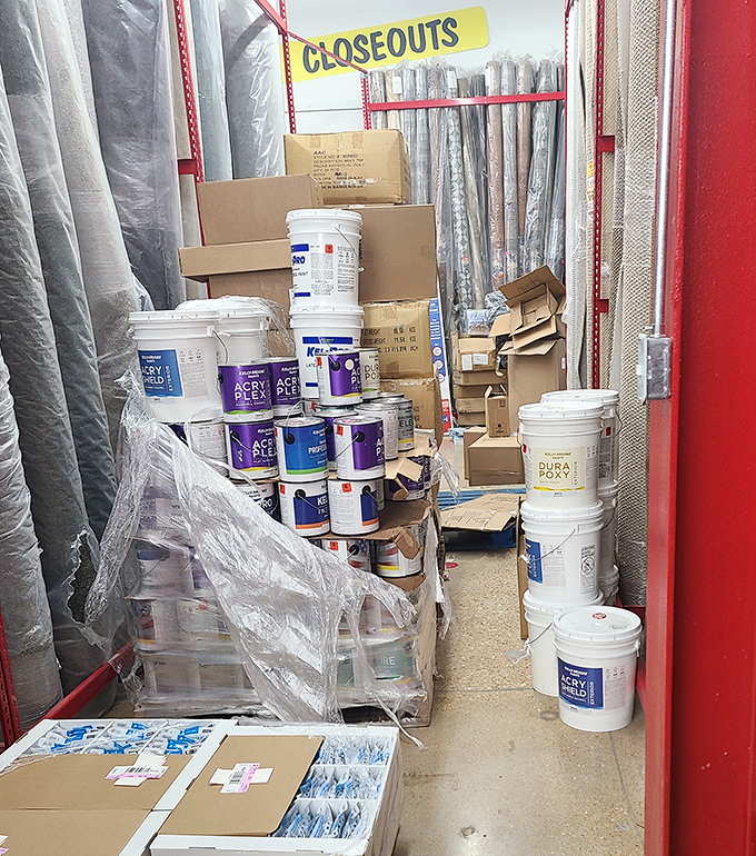 Paint buckets and home improvement dreams collide in aisles where DIY meets "why pay more?"