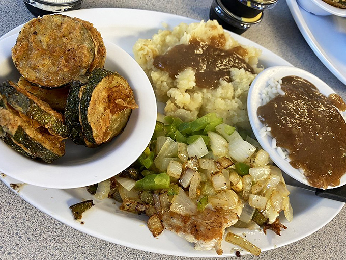 Fried zucchini, mashed potatoes with gravy, and saut&eacute;ed onions&mdash;a plate that proves vegetables can be just as comforting as dessert.