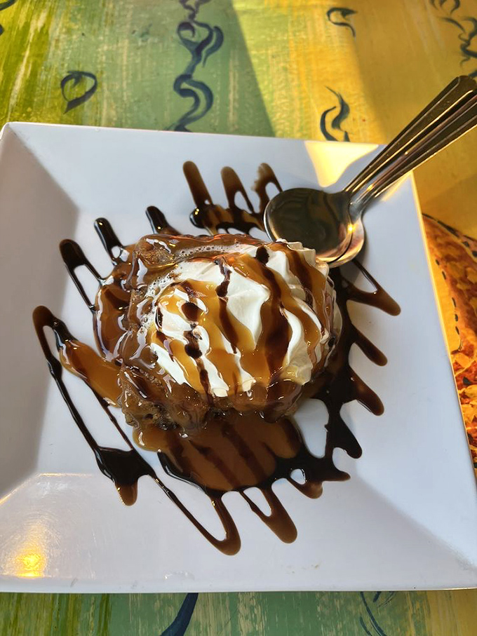 A scoop of vanilla ice cream drizzled with caramel and chocolate that makes you wonder why we complicate desserts when simplicity tastes this good.