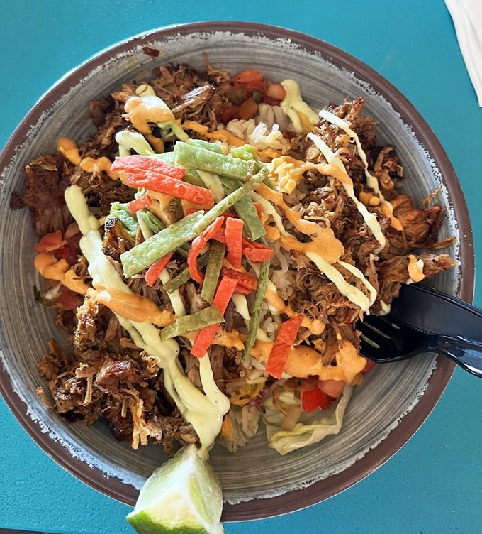 The pulled pork bowl transforms humble ingredients into something magnificent&mdash;like if your grandmother's comfort food went to culinary school in the Caribbean.