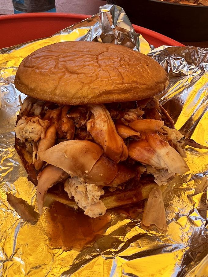 This sandwich isn't messing around. Stacked higher than Florida's humidity levels, it's a towering achievement in pulled chicken architecture.