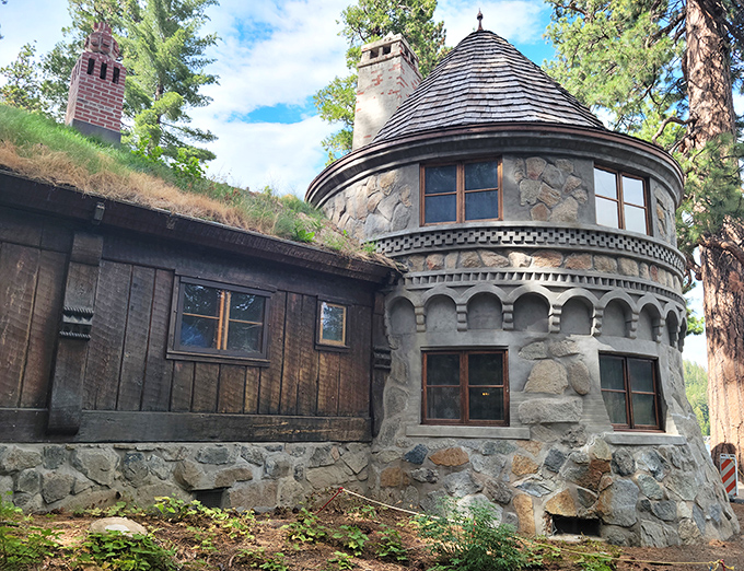 Where stone meets sky. The castle's rounded turret and sod roof (yes, that's actual grass growing up there!) showcase authentic Nordic building techniques.