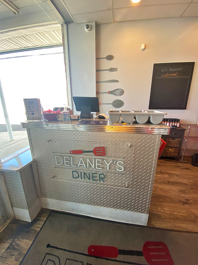 The host stand doubles as functional art&mdash;diamond plate metal with utensil silhouettes announces "serious about food" without saying a word.