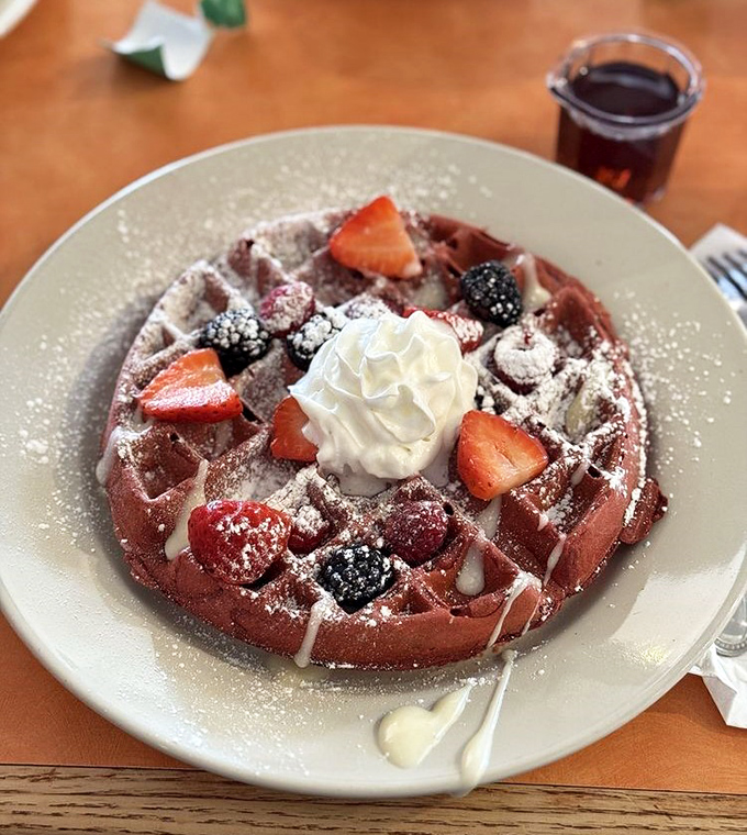 Red velvet waffle that looks like it escaped from a dessert menu but belongs perfectly on your breakfast plate.