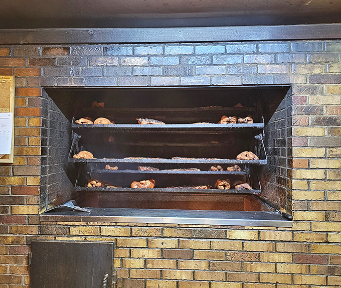 The holy grail of barbecue: a proper brick smoker with meat in various stages of transformation. This isn't cooking&mdash;it's a slow-motion miracle.