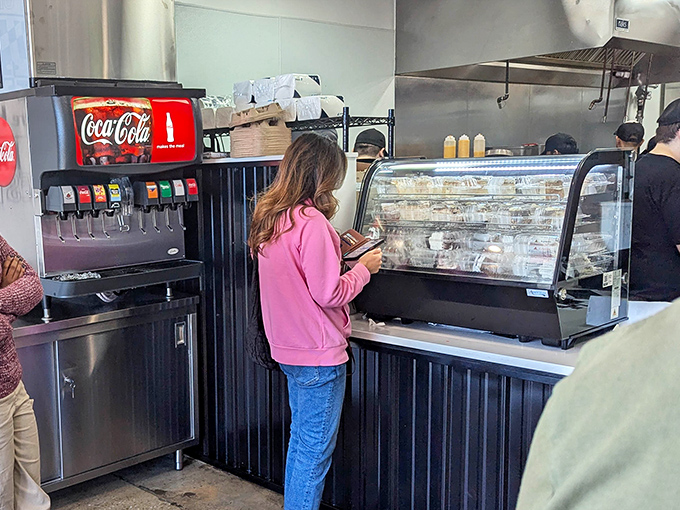 Where the magic happens – customers place their orders while staff orchestrates the symphony of sizzling meat and melting cheese.