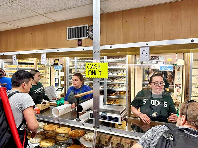 The "CASH ONLY" sign is like a time machine to simpler days. These customers know some treasures can't be bought with plastic.