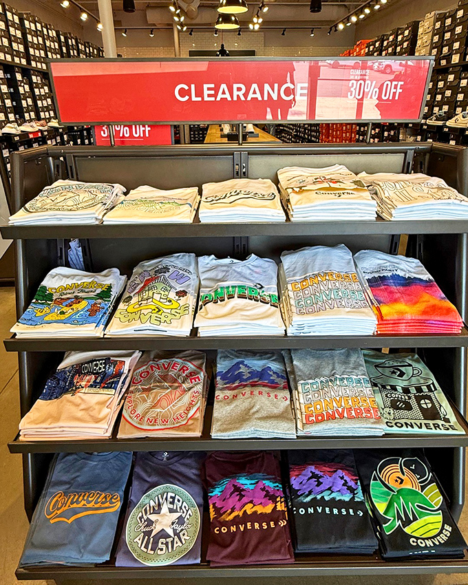 Converse t-shirts stacked with military precision, each one promising to make you look effortlessly cool without trying too hard.