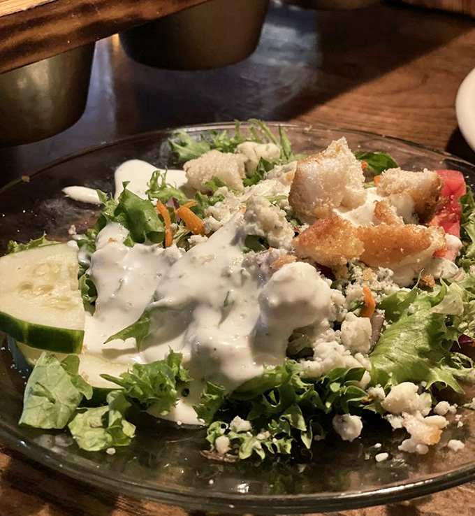 A salad that understands its supporting role&mdash;fresh greens, croutons, and blue cheese creating the perfect opening act before the beef headliner arrives.