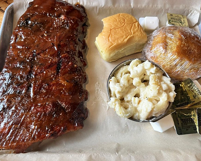 Ribs glazed to such glistening perfection they could double as modern art. The mac and cheese sidekick refuses to be overshadowed.