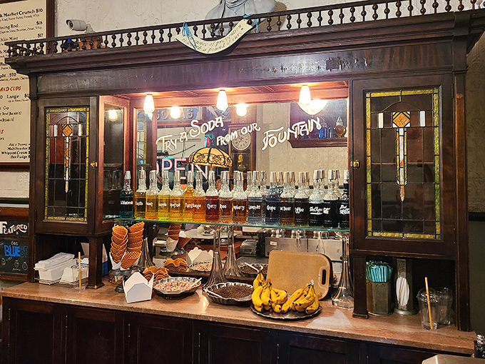 Behind this stained glass cabinet lies liquid alchemy. Those syrup bottles aren't just ingredients&mdash;they're potions waiting to transform ordinary sodas into memories.