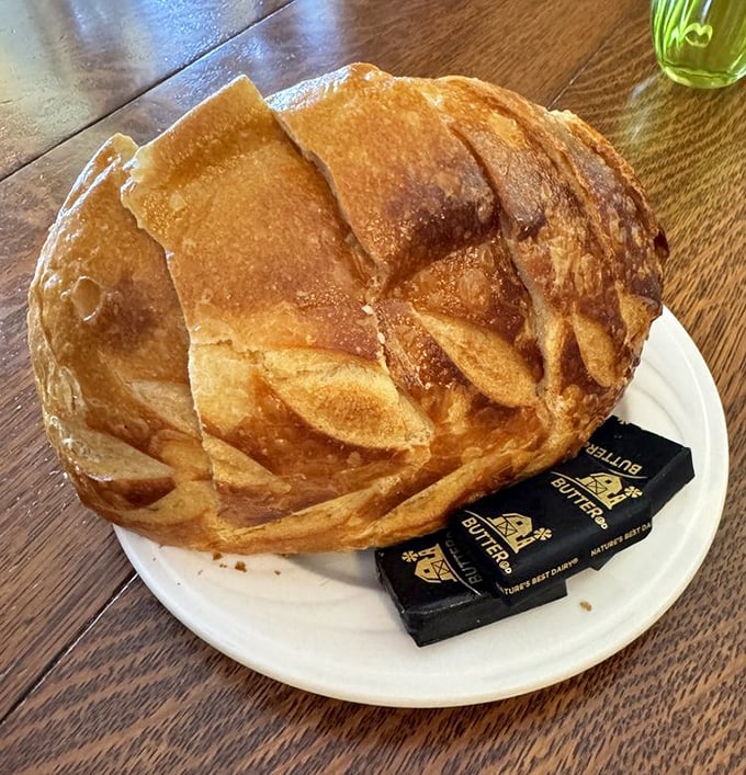 The sourdough arrives like a golden dome of possibility, with butter standing by for its inevitable, delicious fate.