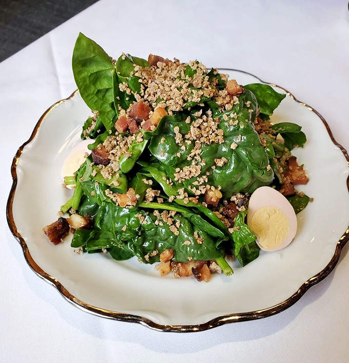 A spinach salad that could convert vegetable skeptics &ndash; fresh greens, savory bits, and a perfect egg create a starter worth celebrating.