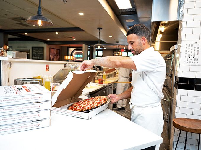The pizza maker's hands tell stories of thousands of perfect pies. This isn't fast food&mdash;it's slow food worth waiting for.