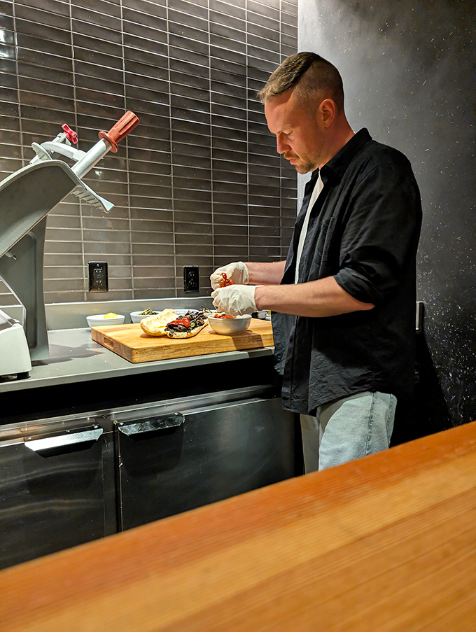 Craftsmanship in action. Each hand movement is the result of countless hours perfecting the art of pizza-making.