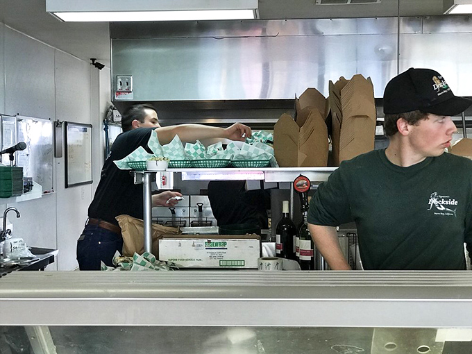 Behind the scenes, the kitchen crew moves with the practiced choreography of people who know fresh seafood waits for no one.