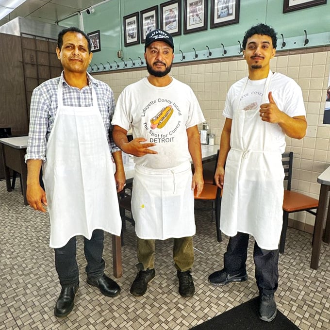 The maestros behind the magic, wearing their crisp white aprons like badges of honor. These are the keepers of the coney flame.