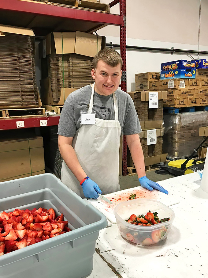 Fresh strawberries being prepped for pie duty. From farm to filling, the journey of perfect fruit heading toward its destiny.