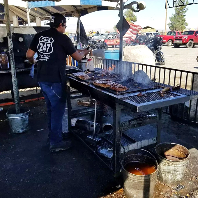 BBQ alchemy in action. The outdoor grill master tends to ribs with the focus of a surgeon and the soul of an artist.
