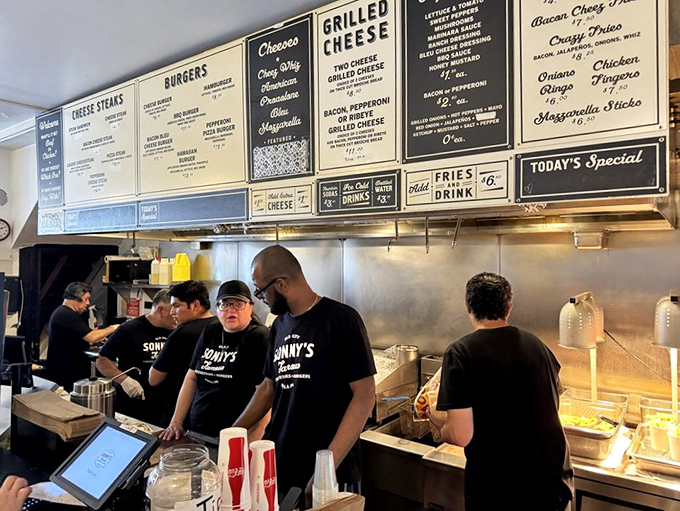 The kitchen crew moves with the choreographed precision of people who've turned sandwich-making into performance art.