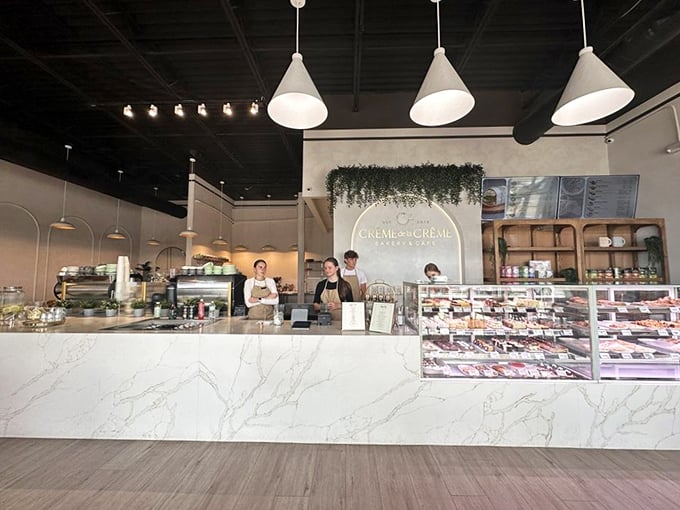 The pristine counter showcases both the pastries and the care that goes into creating them. Bakery theater at its finest.