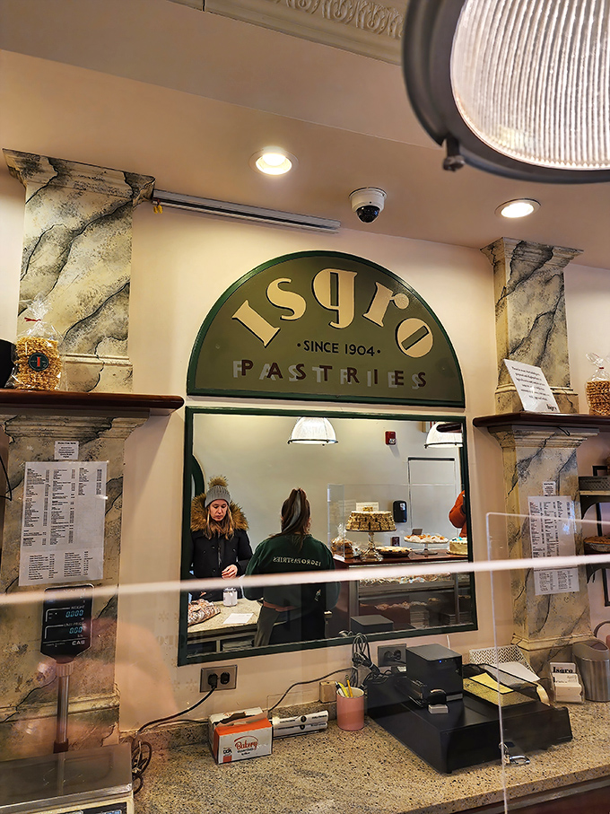 Behind the counter, where the magic happens. The staff moves with practiced efficiency honed by years of handling precious cargo.