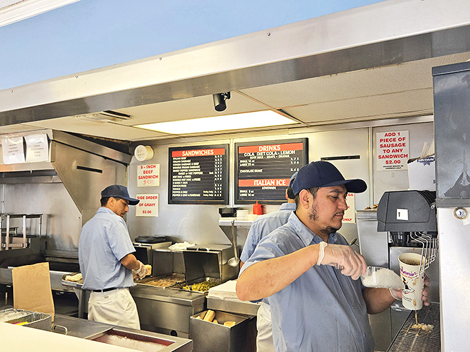 The blue-shirted maestros of meat, orchestrating a symphony of beef, bread, and giardiniera with practiced precision.