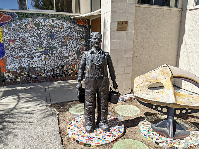 This bronze tribute captures the spirit of the towers' creator&mdash;buckets in hand, ready to transform discarded objects into enduring beauty.