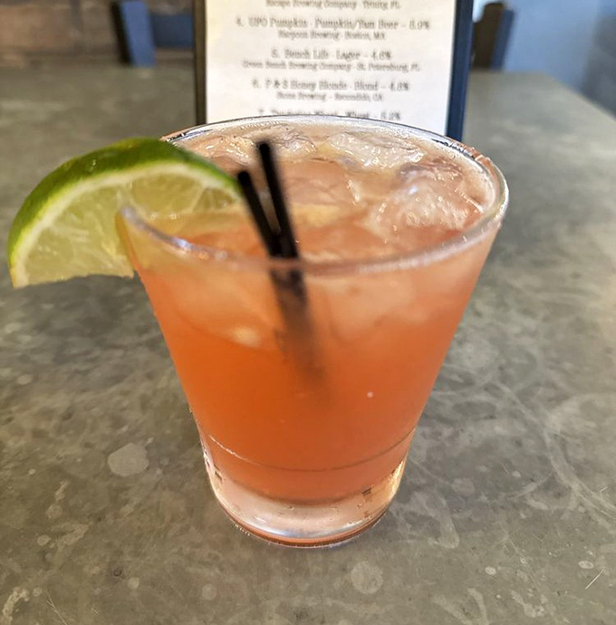 This isn't just a strawberry margarita; it's Florida sunshine in liquid form, with a lime wedge perched on the rim like a tiny tropical hat.